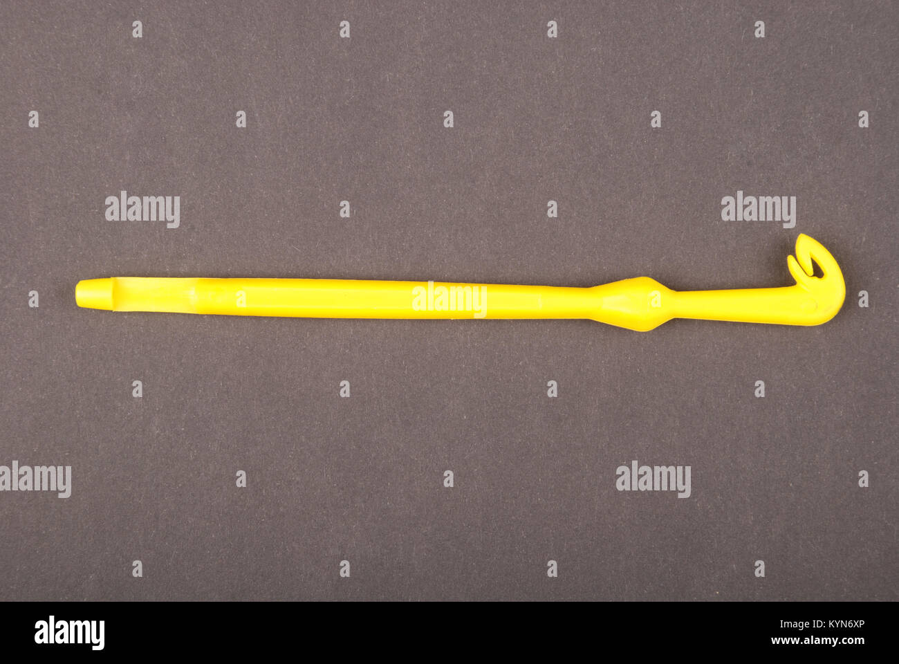 One yellow loop tier isolated on black background Stock Photo - Alamy