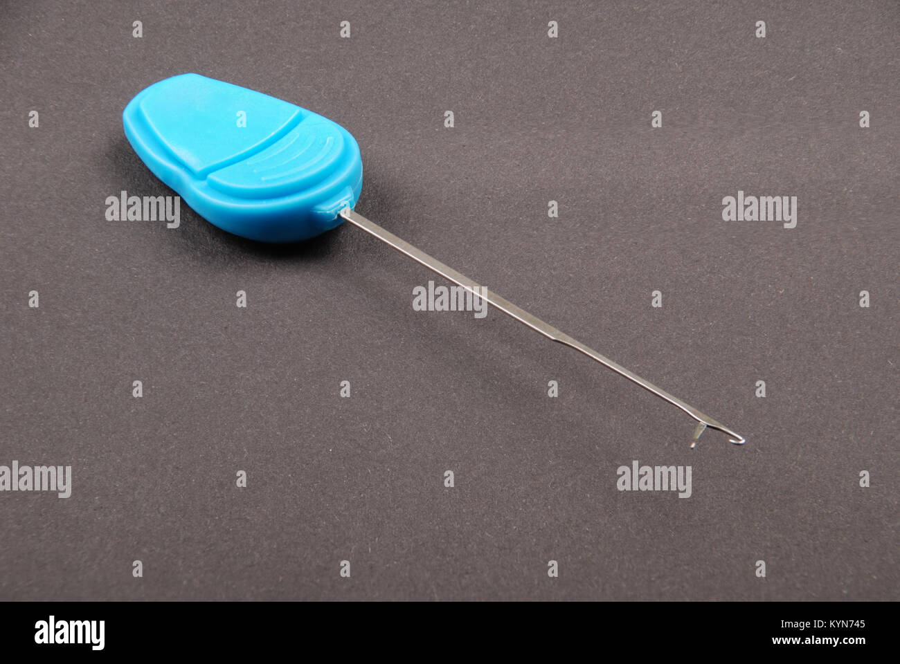 One blue splicing needle isolated on black background Stock Photo - Alamy