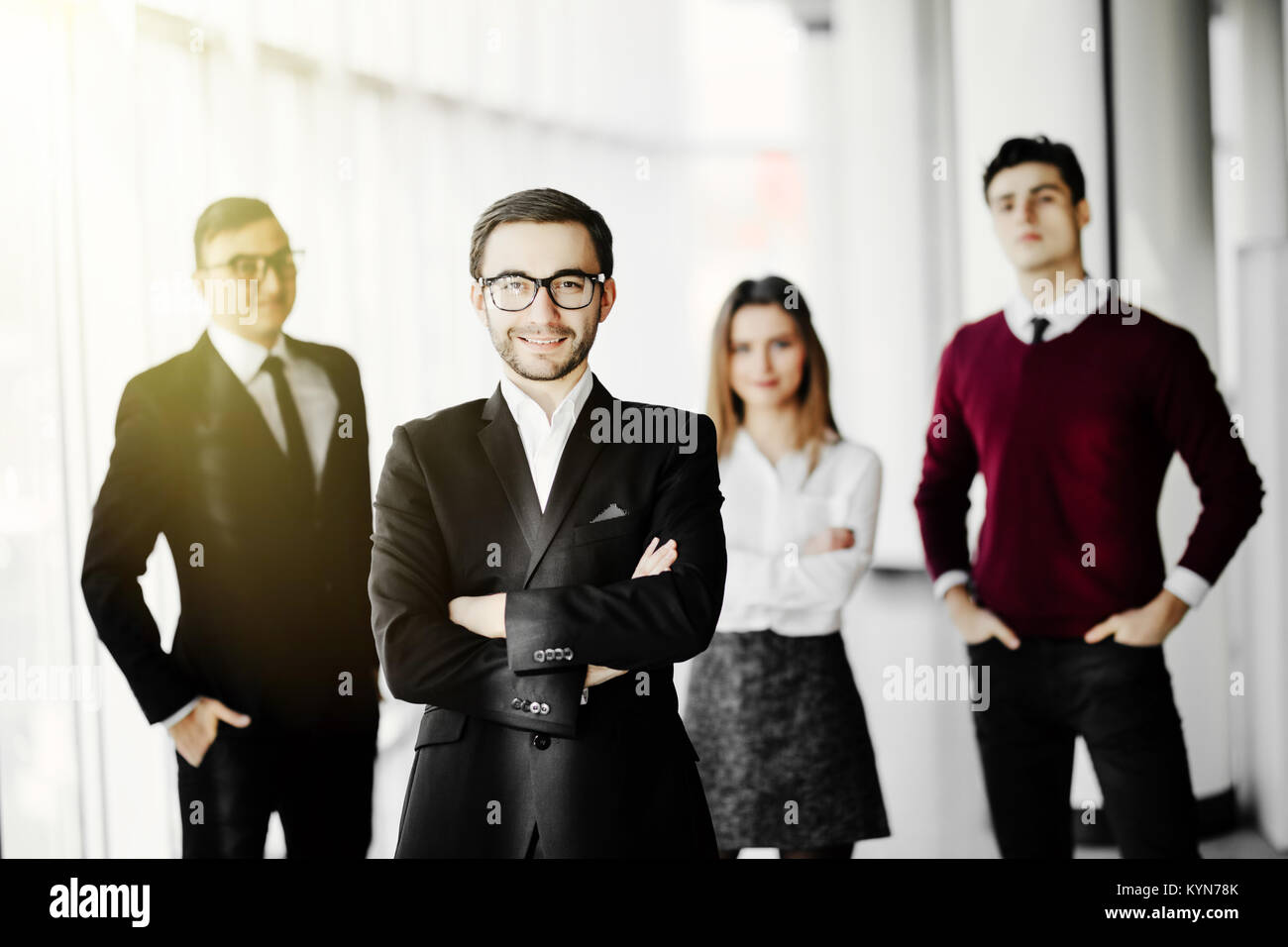 Potrait of a Businessman standing in Front of Business team Stock Photo ...