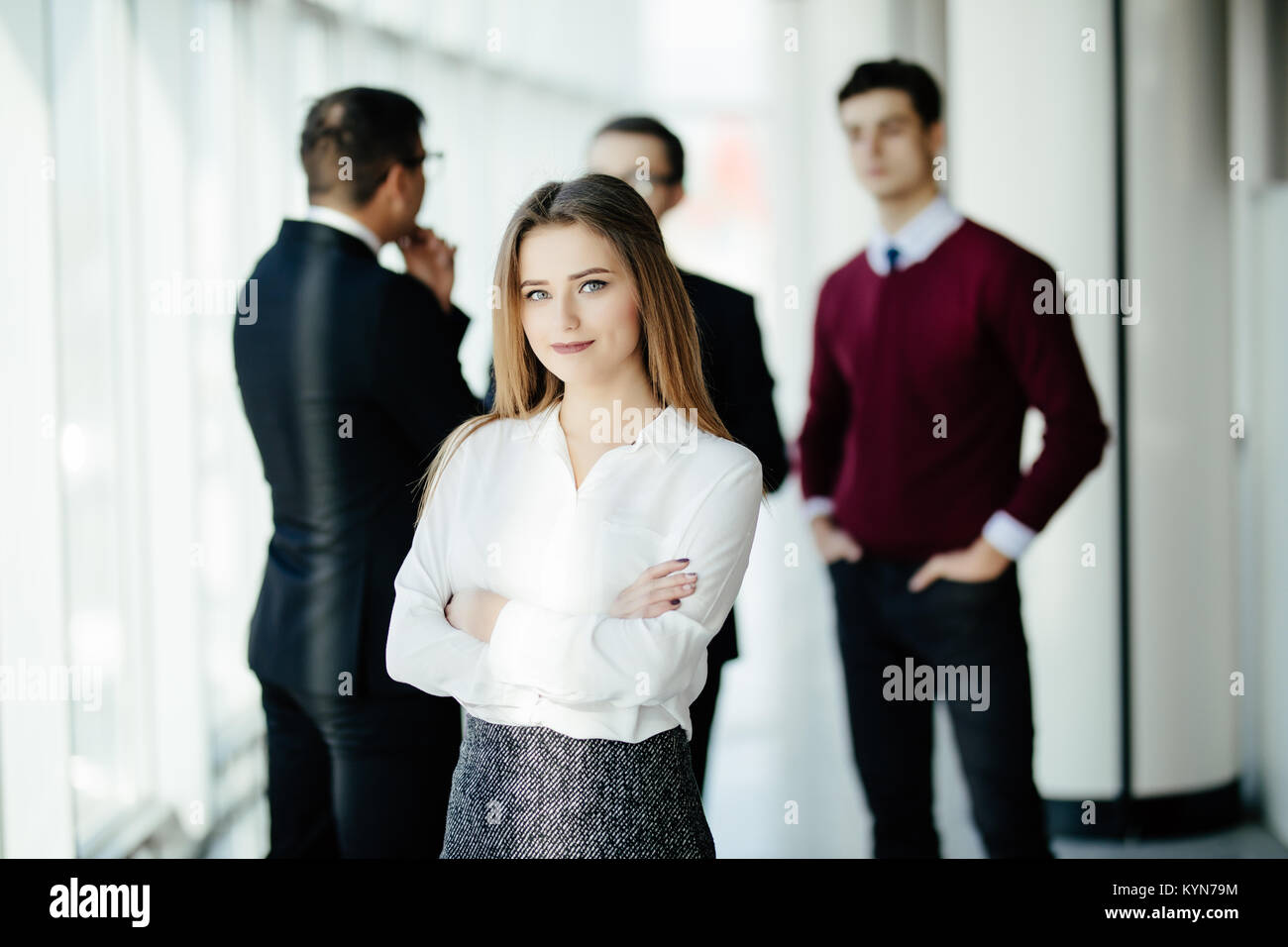 Successful young female manager in front of her team Stock Photo - Alamy