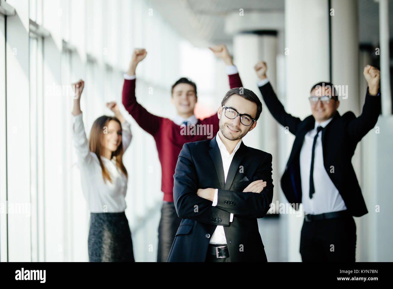 handsome business man in front of his team member celebrating their ...
