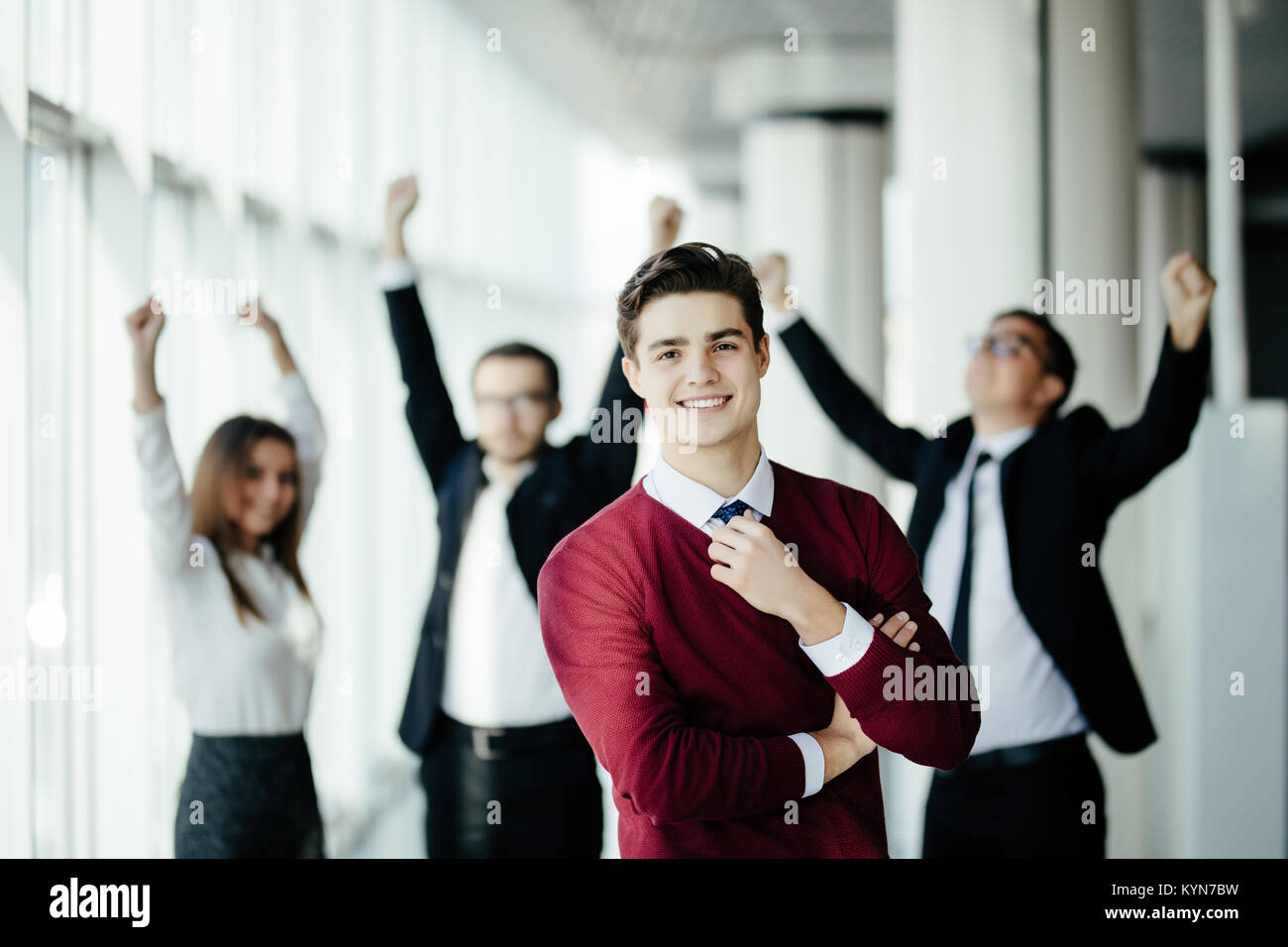 handsome business man in front of his team member celebrating their ...