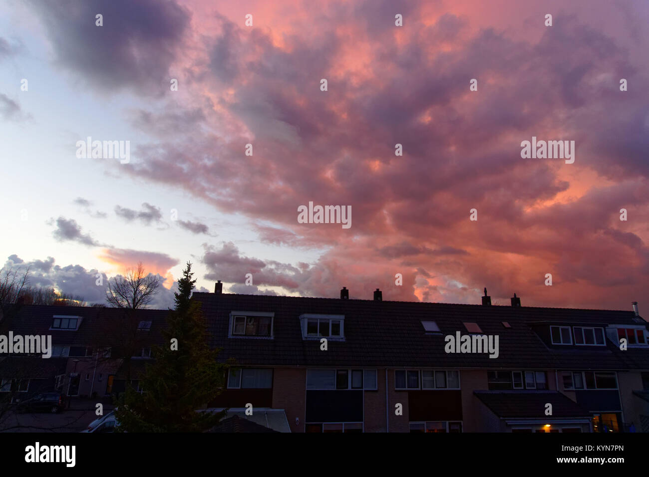 Sunset making the clouds orange Stock Photo - Alamy