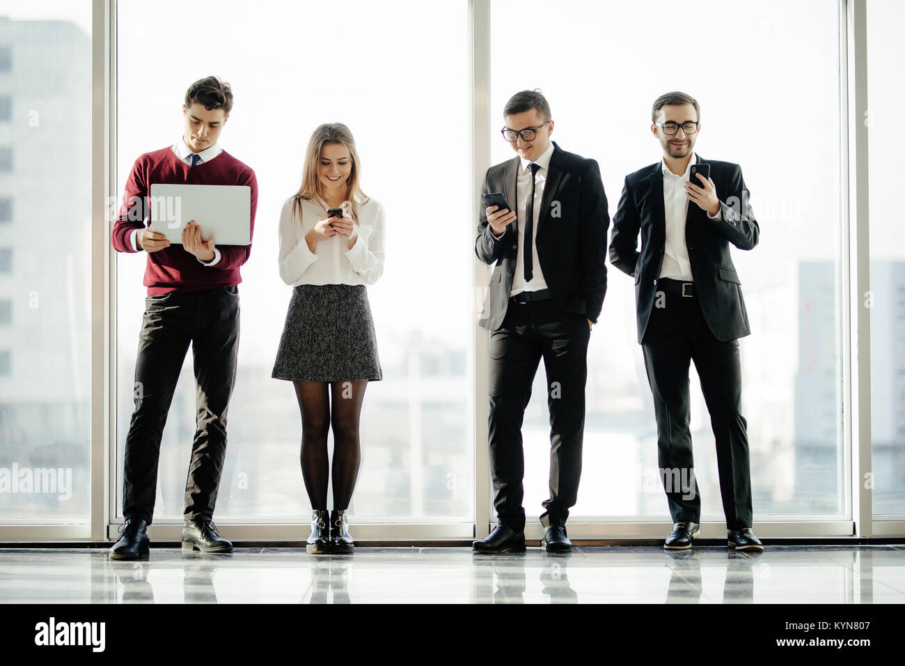 Group Business friends standing and using modern gadgets against ...