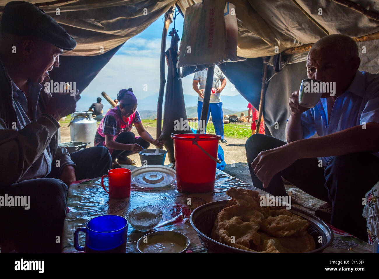 KAZARMAN, KYRGYZSTAN - AUGUST 15: Woman serving kumis, fermented mare's ...