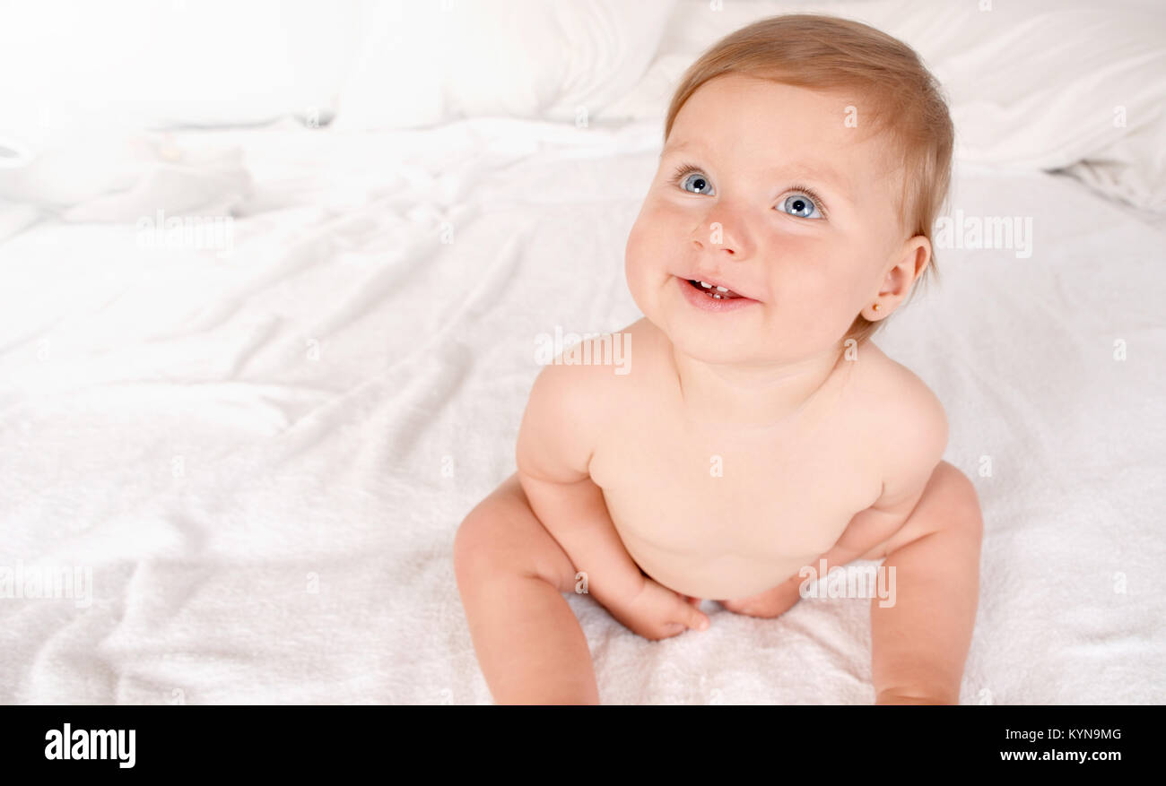 Happy newborn baby smiling and looking at camera. Top view. Happy ...