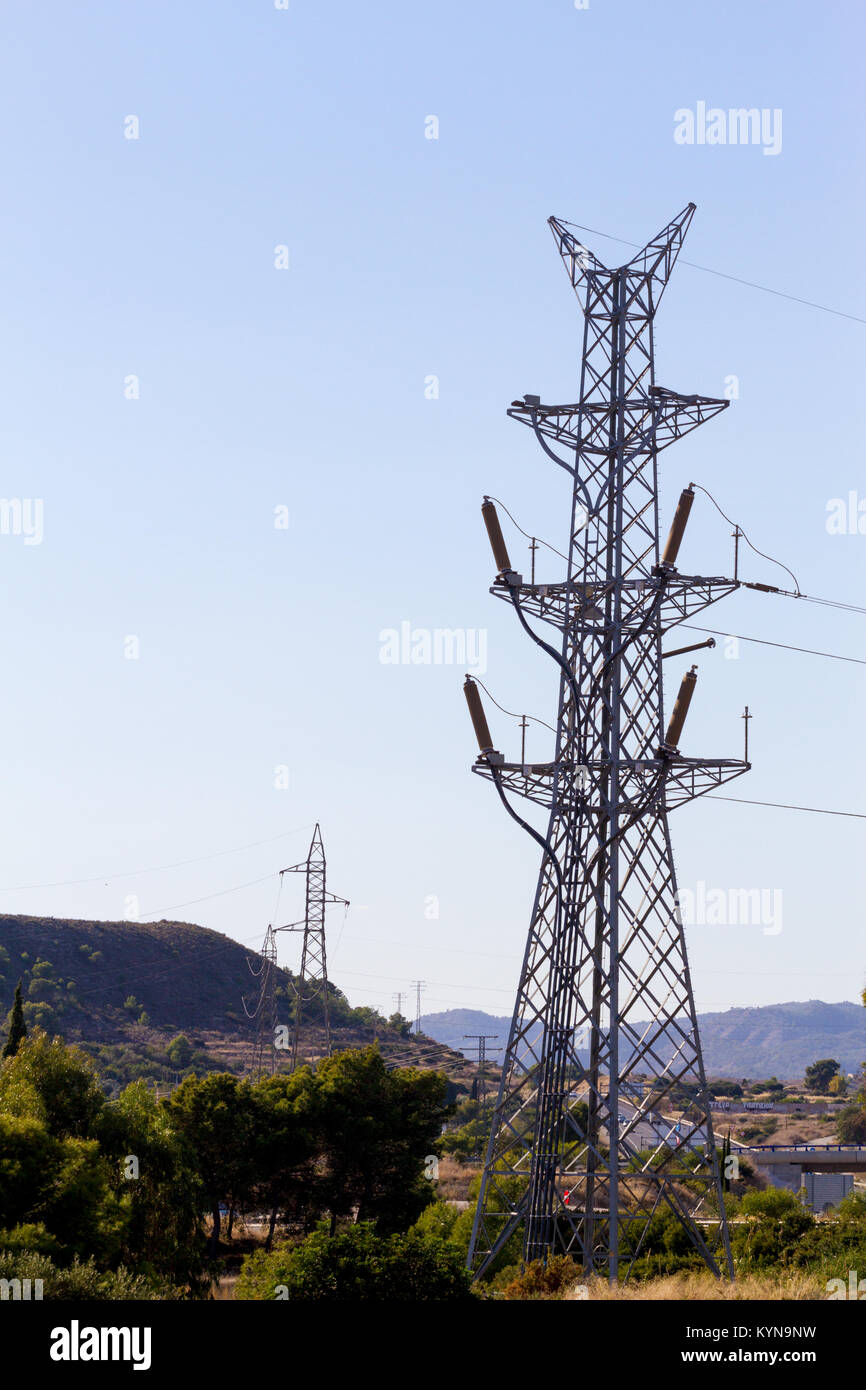 High voltage power lines and electric transmission pylon outdoor ...