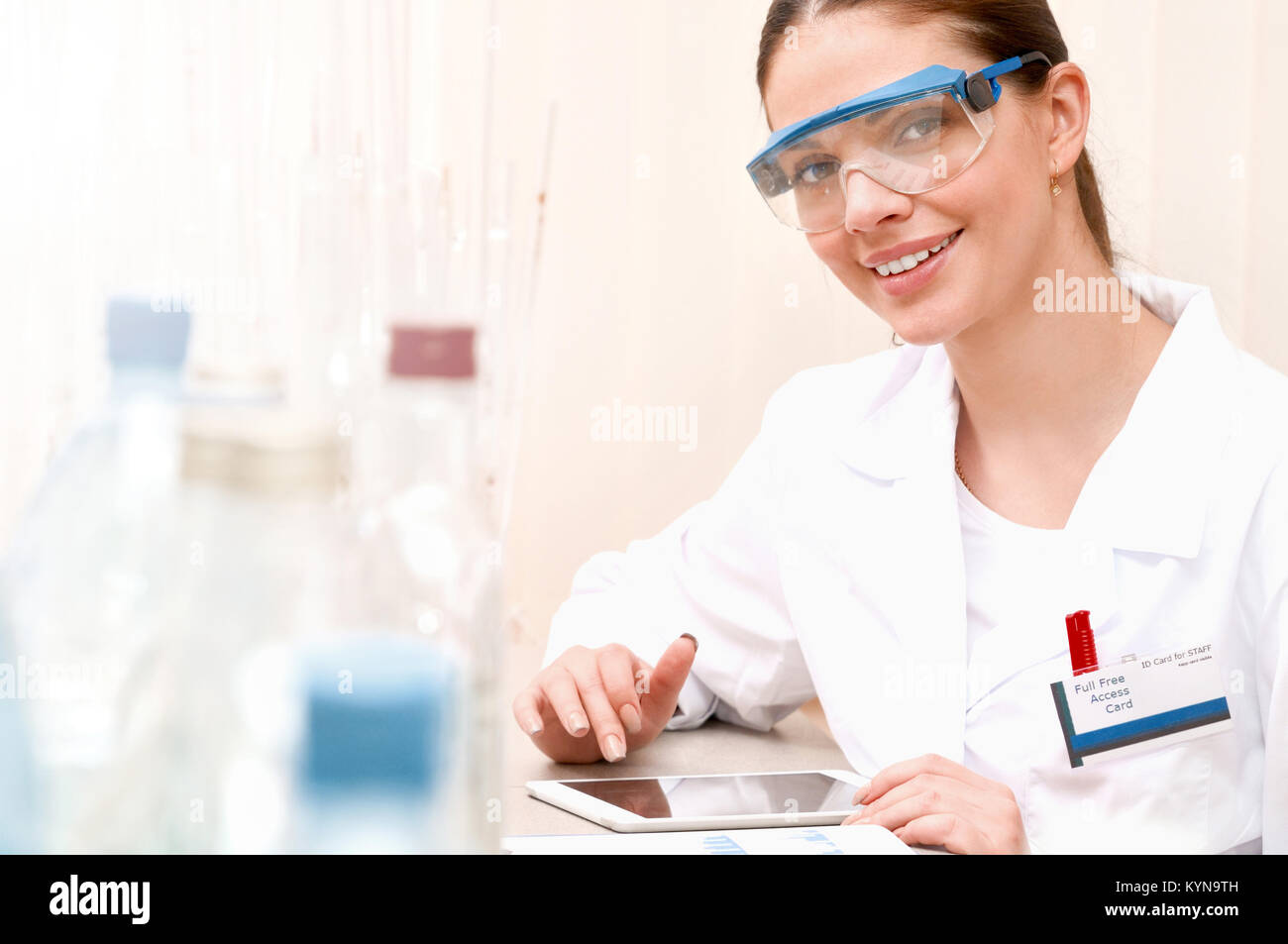 young woman scientist with tablet pad write data research in clinical ...