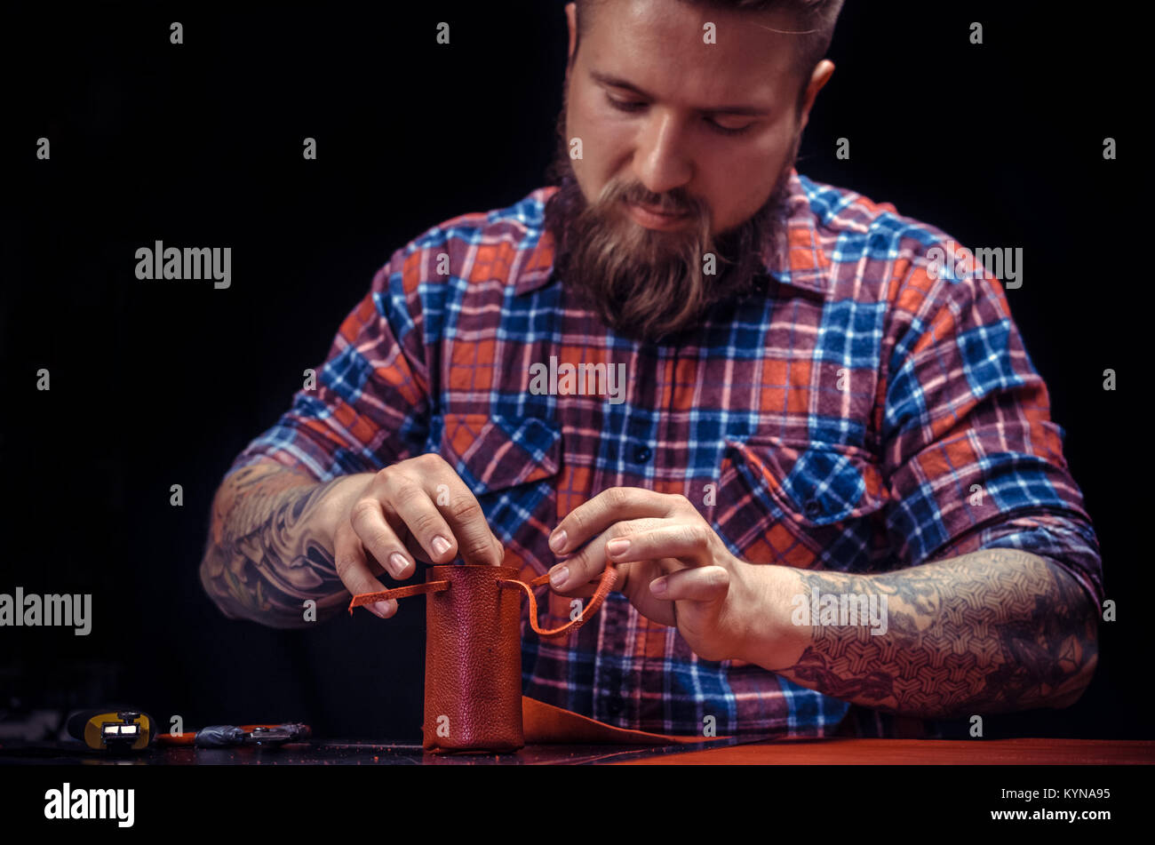 Currier wording with leather goods Stock Photo - Alamy