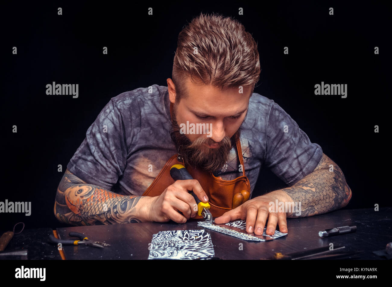 Leather master works with leatherwork in his work area Stock Photo - Alamy
