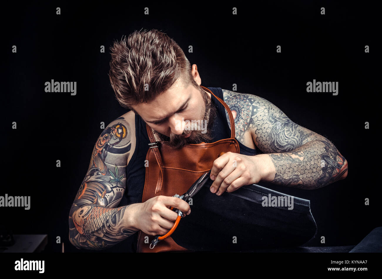Currier creates quality product of leather at his leather studio Stock ...