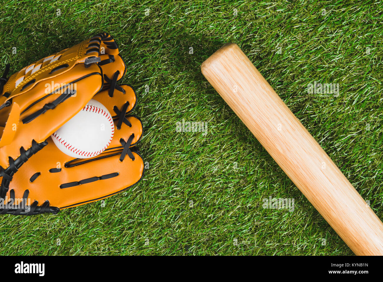 Top view of baseball bat with glove and ball on green grass Stock Photo ...