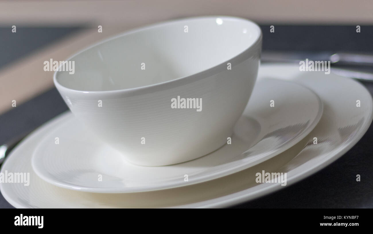 Table setting with dinner plate empty round white plate on dark ...