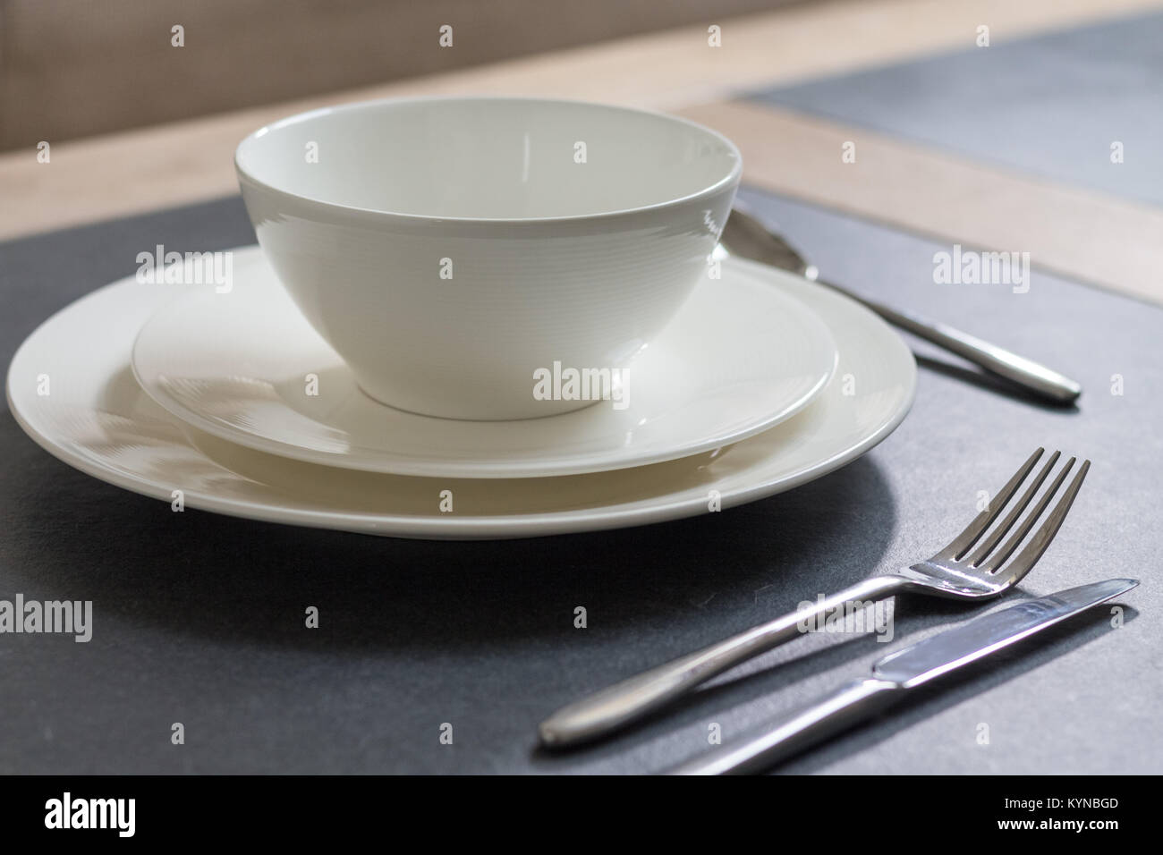 Table setting with dinner plate empty round white plate on dark ...
