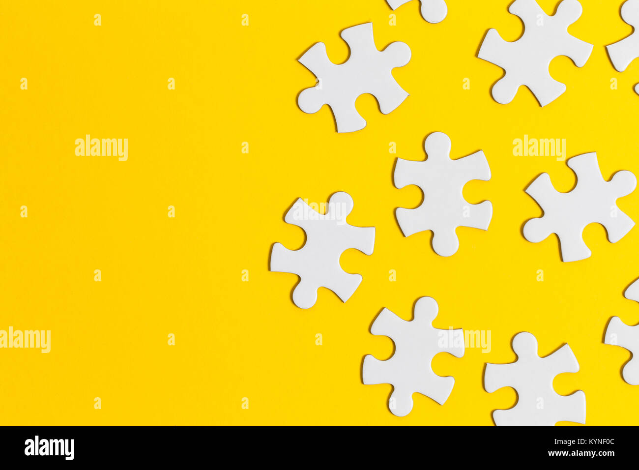 White jigsaw puzzle pieces on a yellow background. Business solution ...