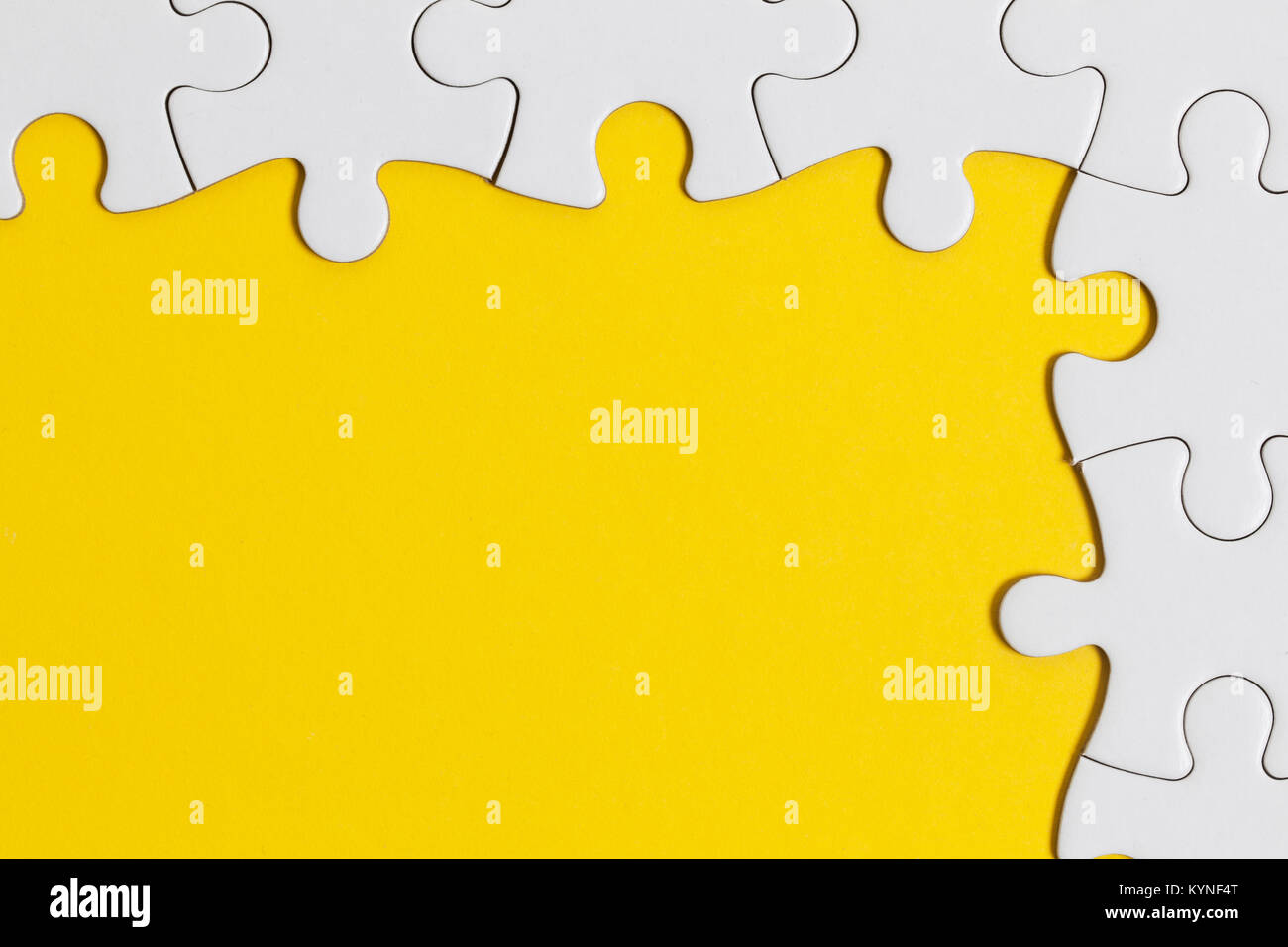White jigsaw puzzle pieces on a yellow background. Business solution ...