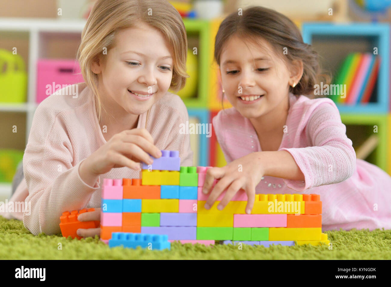 girls playing with colorful blocks Stock Photo - Alamy