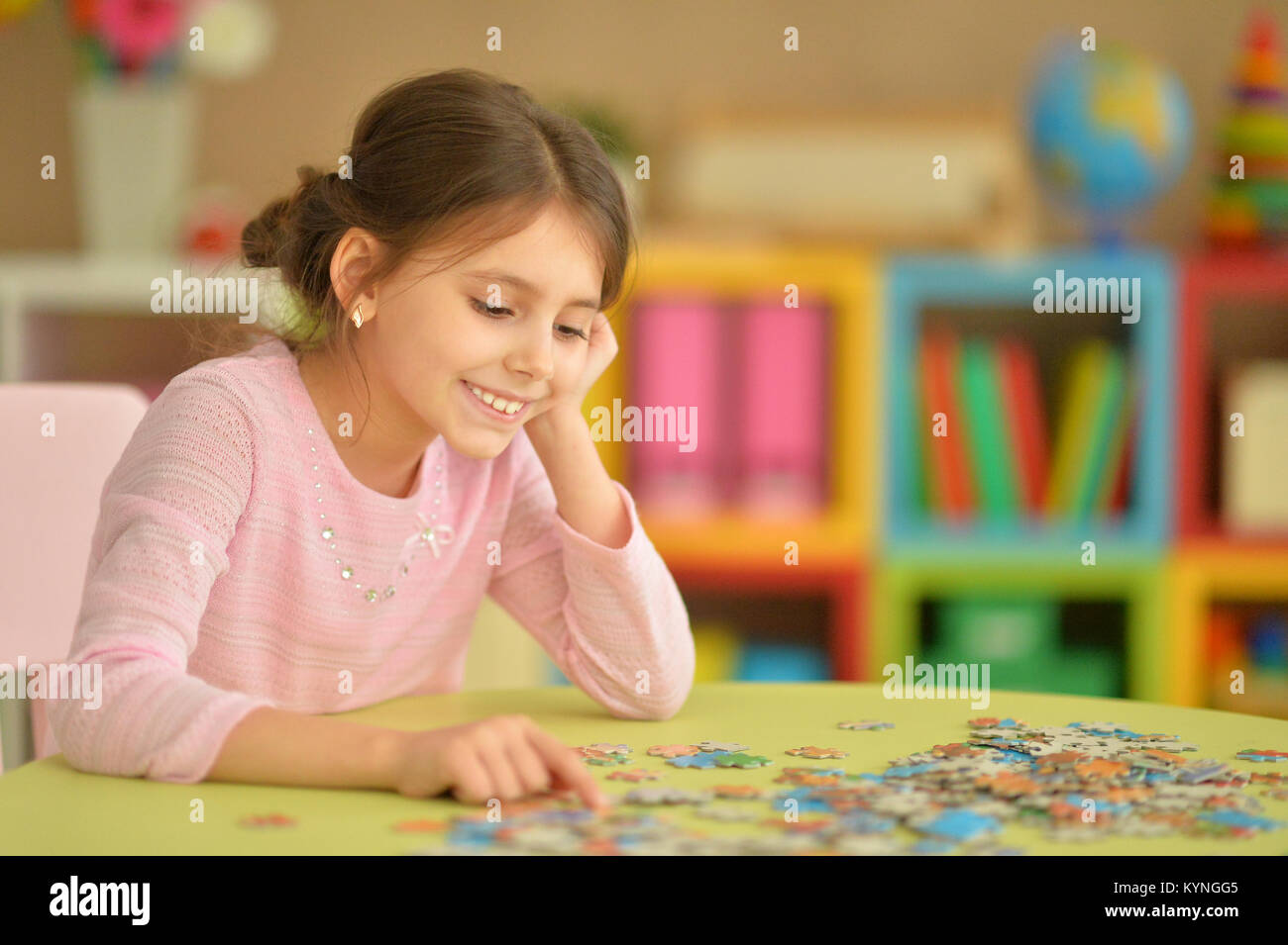 girl collecting puzzles Stock Photo - Alamy