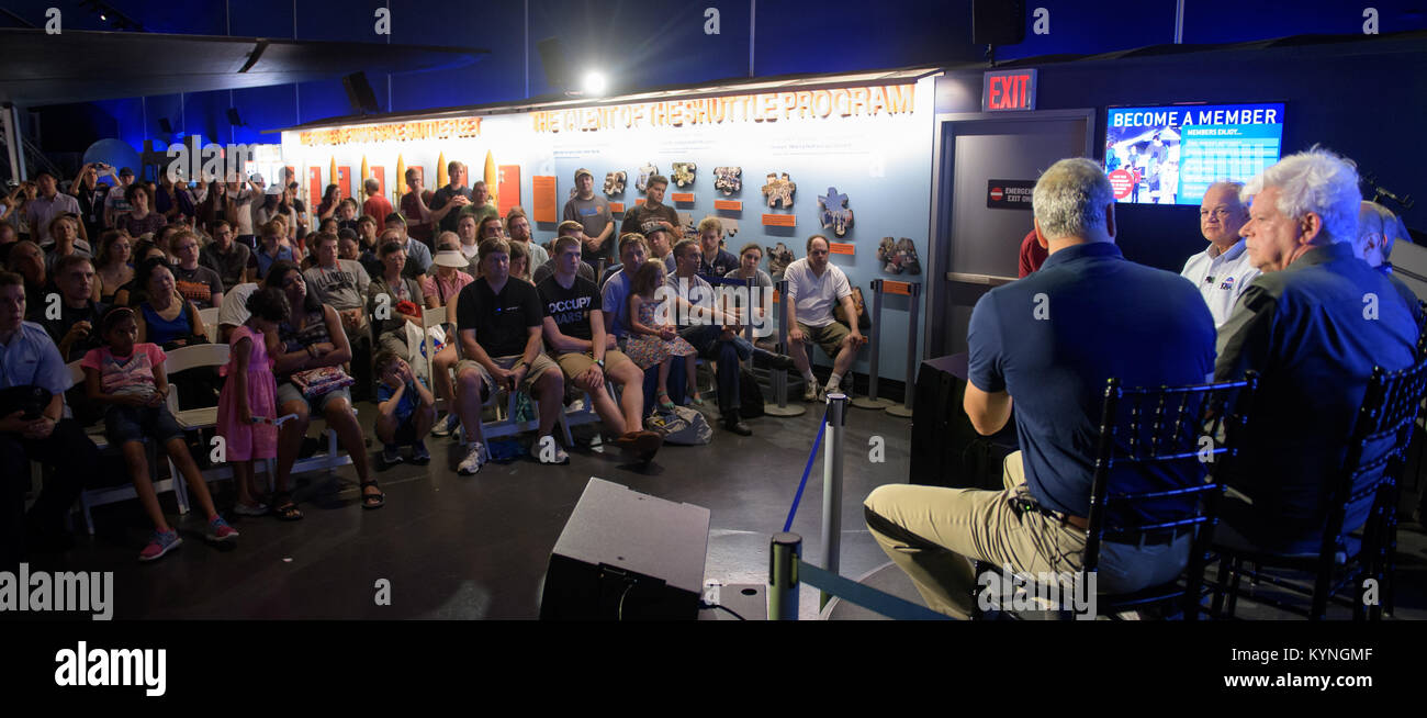 Audience members, seated under the wing of the space shuttle Enterprise ...