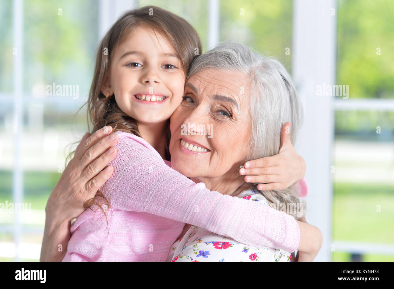 little girl hugging grandmother Stock Photo - Alamy