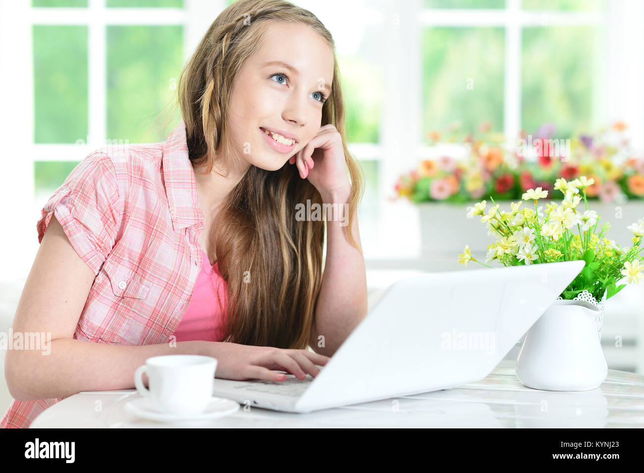 Teen girl using laptop Stock Photo - Alamy