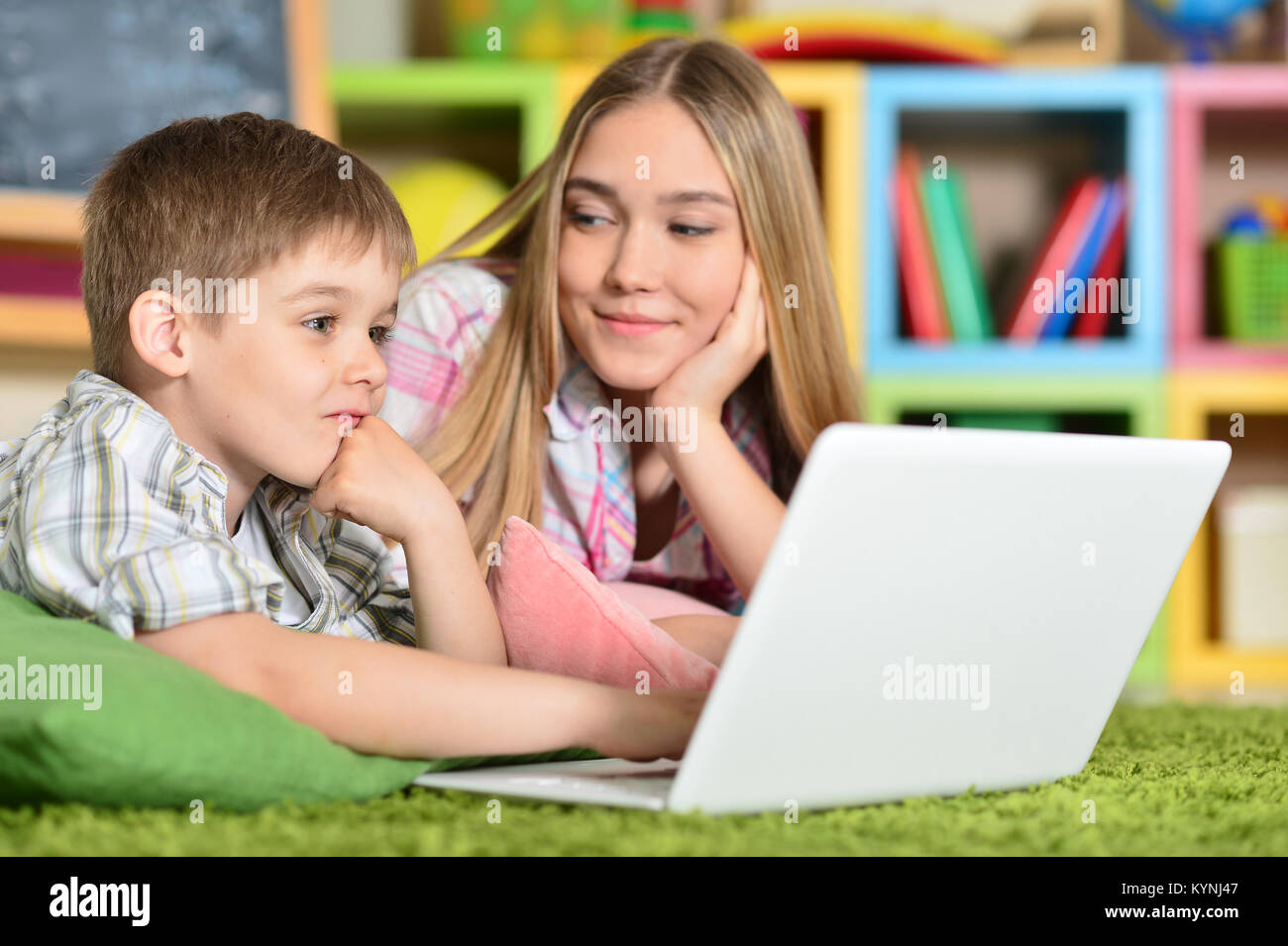 Brother and sister using laptop Stock Photo - Alamy