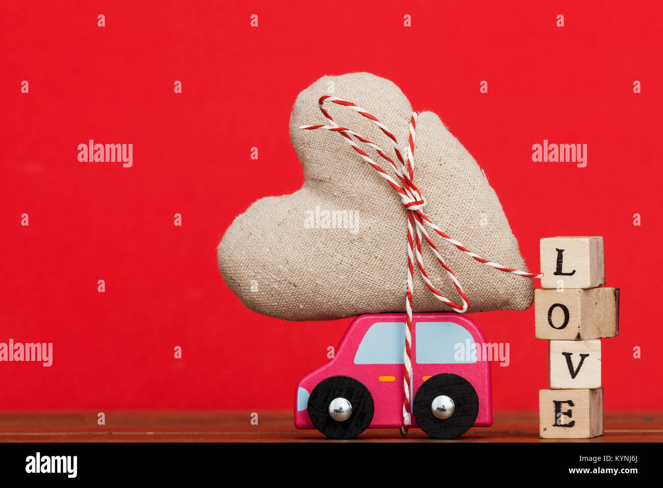 Wodden toy car carrying a love heart. Valentines day, mothers day ...