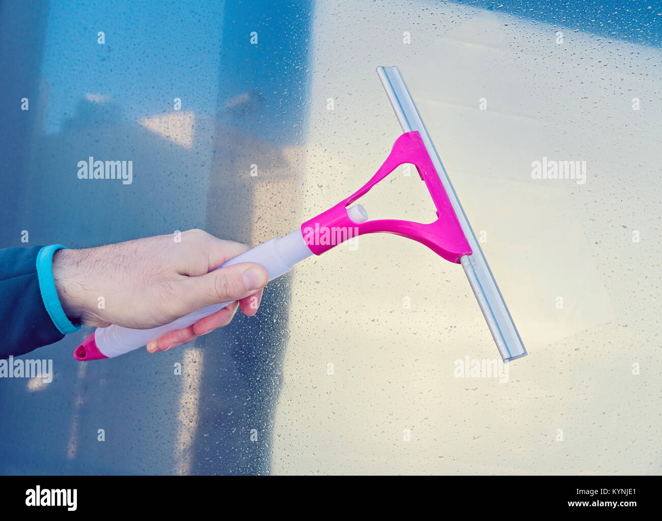 Male hand cleans glass window with Window Wiper Squeegee Stock Photo ...