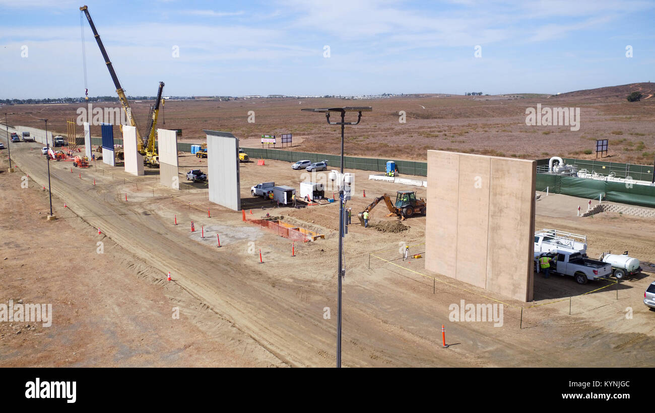 Construction teams are seen preparing several border wall prototypes ...