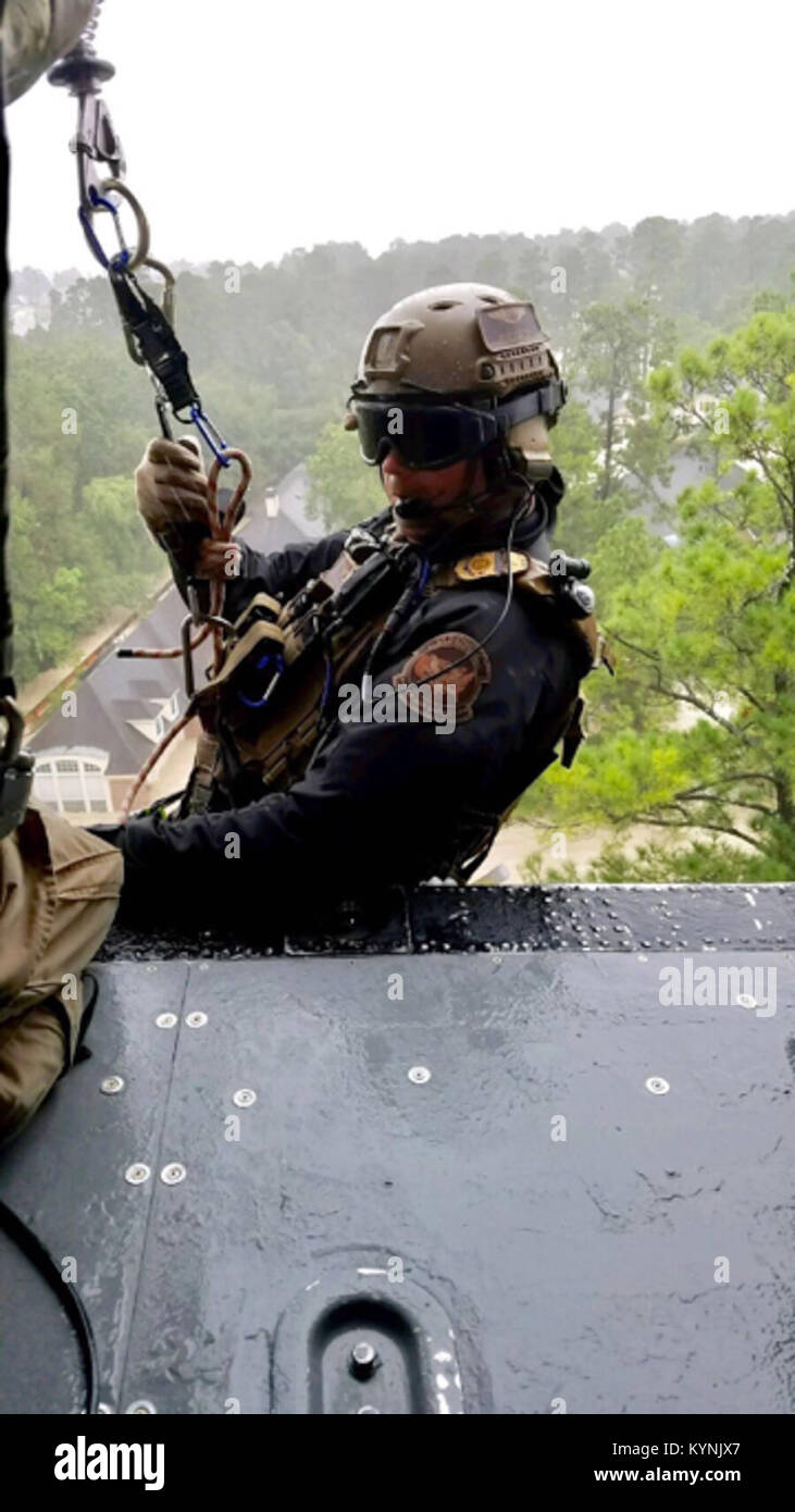 A CBP Air and Marine Operations agent prepares to drop out of a UH-60 ...