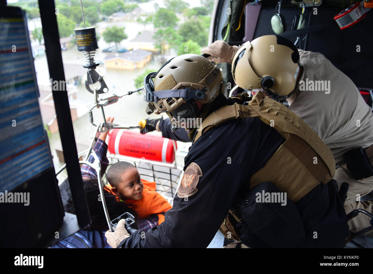 a CBP Air and Marine Operations black hawk aircrew works to bring a ...