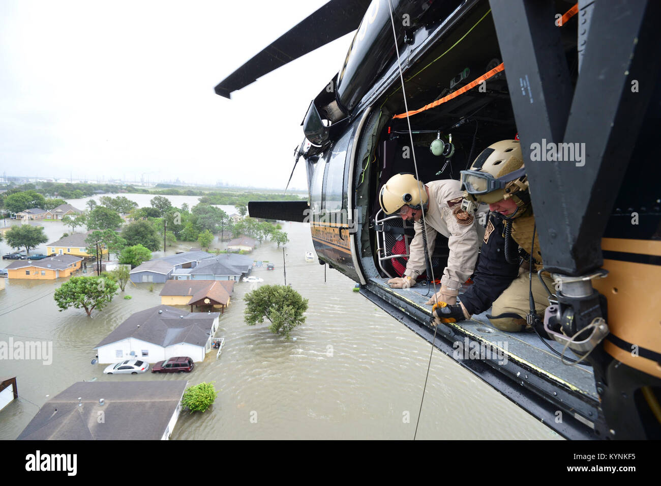 a CBP Air and Marine Operations black hawk aircrew works to bring a ...