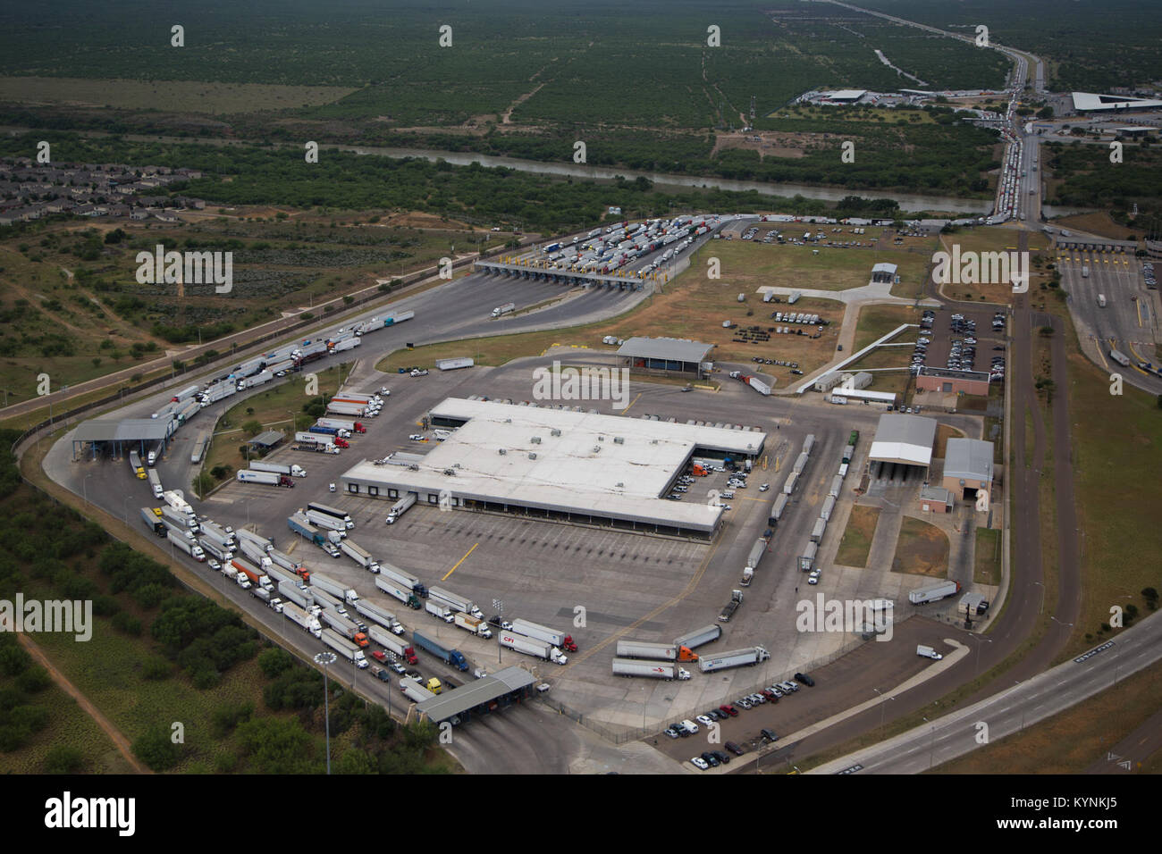 U.S. Customs and Border Protection officers check trucks traveling over ...