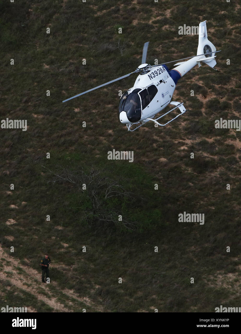 A CBP pilot in an EC120 helicopter conducts aerial patrols along the ...