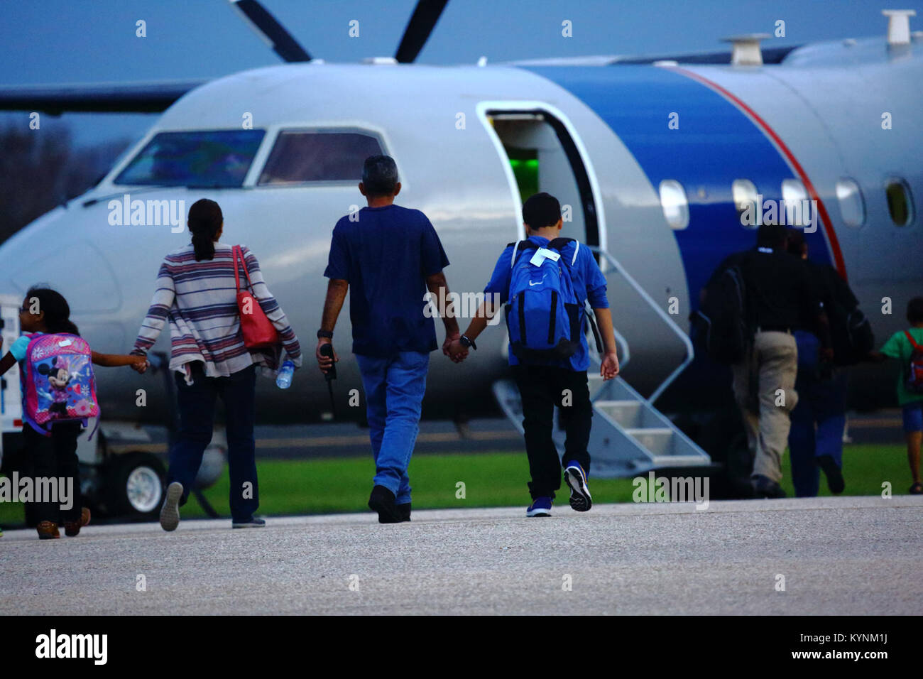 U.S. Customs and Border Protection family members walk towards a U.S ...