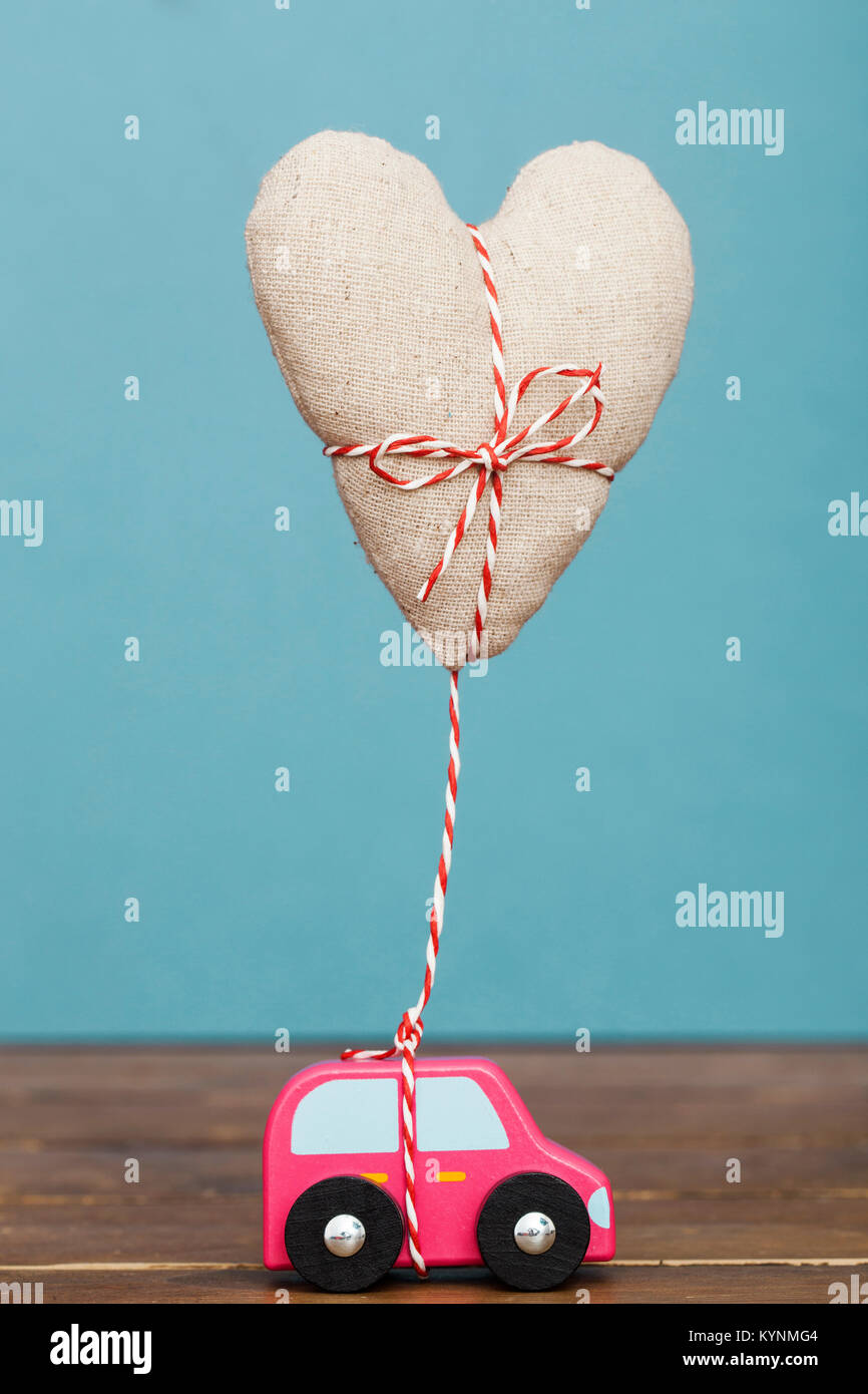 Toy car with a foating love heart. Valentines day, mothers day concept ...