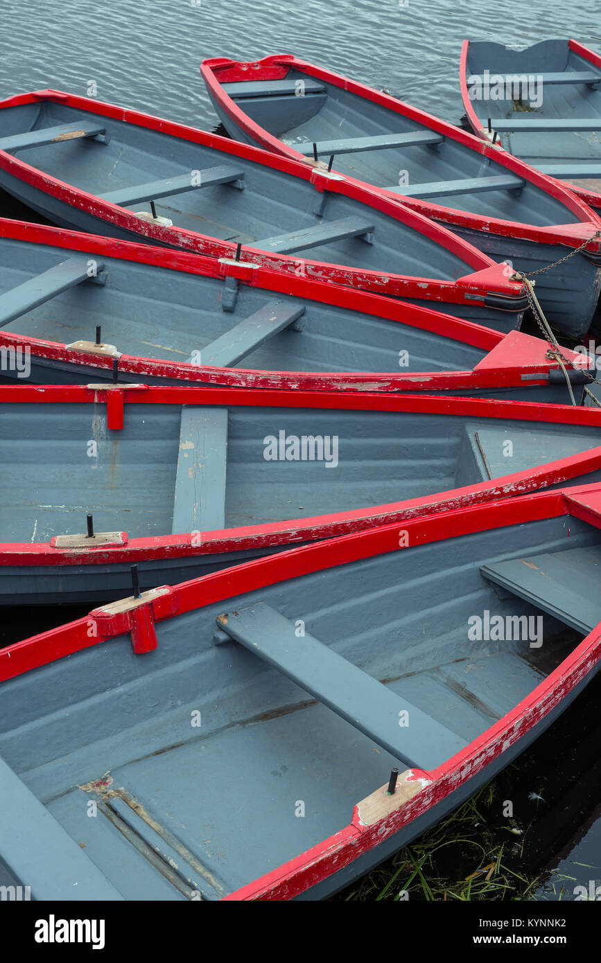 a group of red and grey rowboats Stock Photo - Alamy