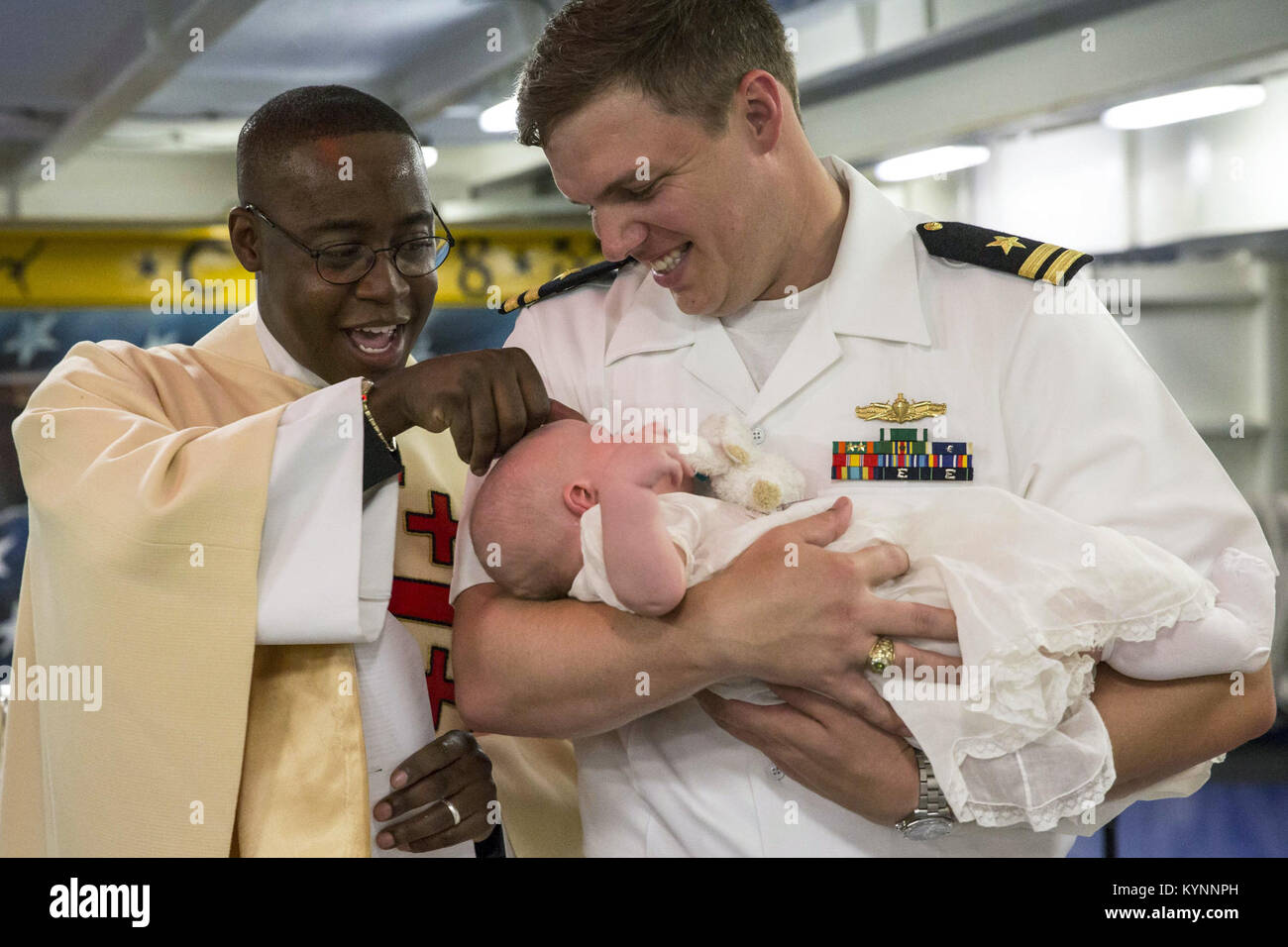 Navy Lt. John Curren participates in a baptism ceremony aboard the Pre ...