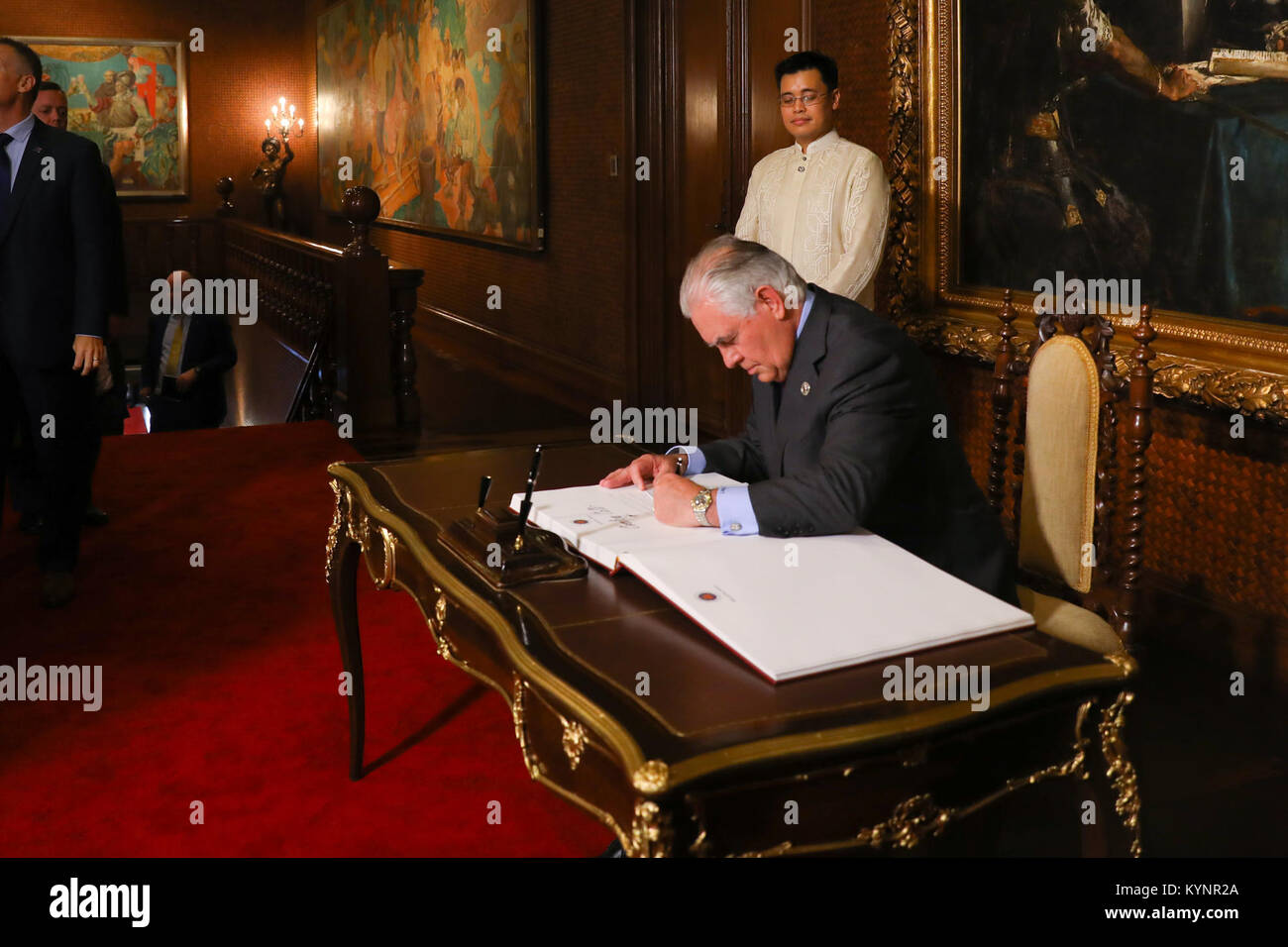 Secretary of State Rex Tillerson signs the guest book during his visit ...