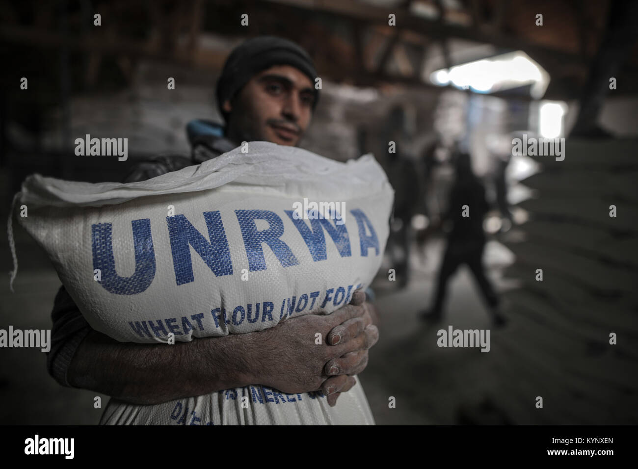Gaza City, Gaza. 15th Jan, 2018. A Palestinian man carries sacks of ...