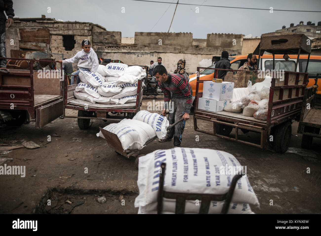 Gaza City, Gaza. 15th Jan, 2018. A Palestinian man carries sacks of ...