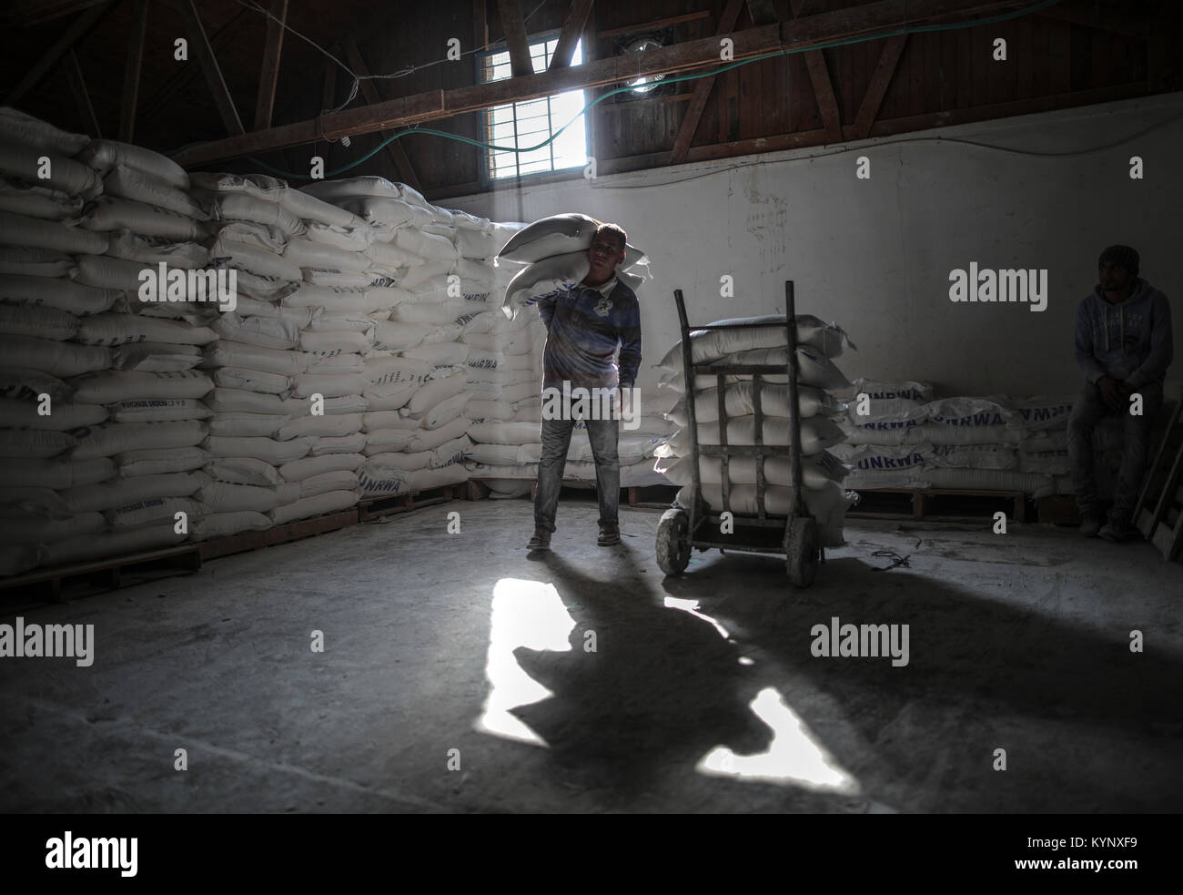 Gaza City, Gaza. 15th Jan, 2018. A Palestinian man carries sacks of ...