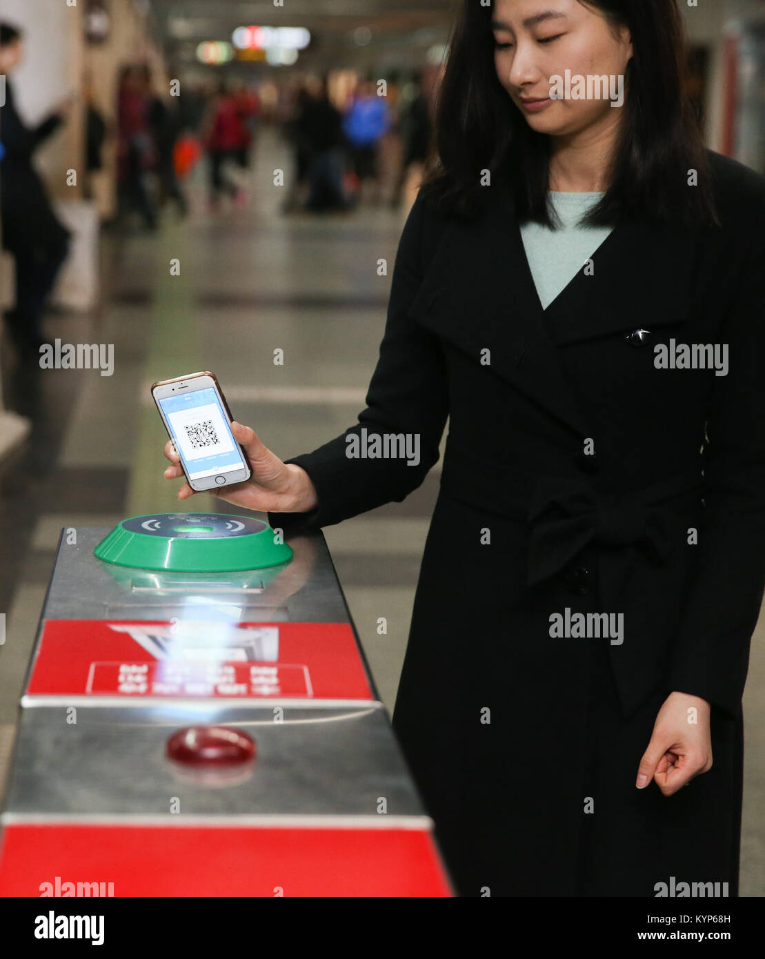 Shanghai. 16th Jan, 2018. A passenger scans QR code at a metro station ...