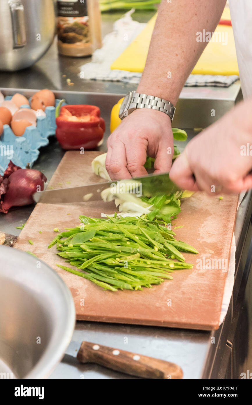 Food preparation - a chef preparing food in a restaurant kitchen Stock ...