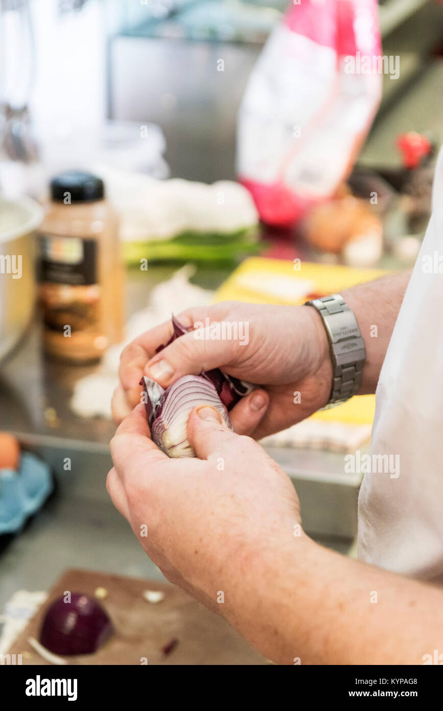 Food preparation - a chef preparing food in a restaurant kitchen Stock ...