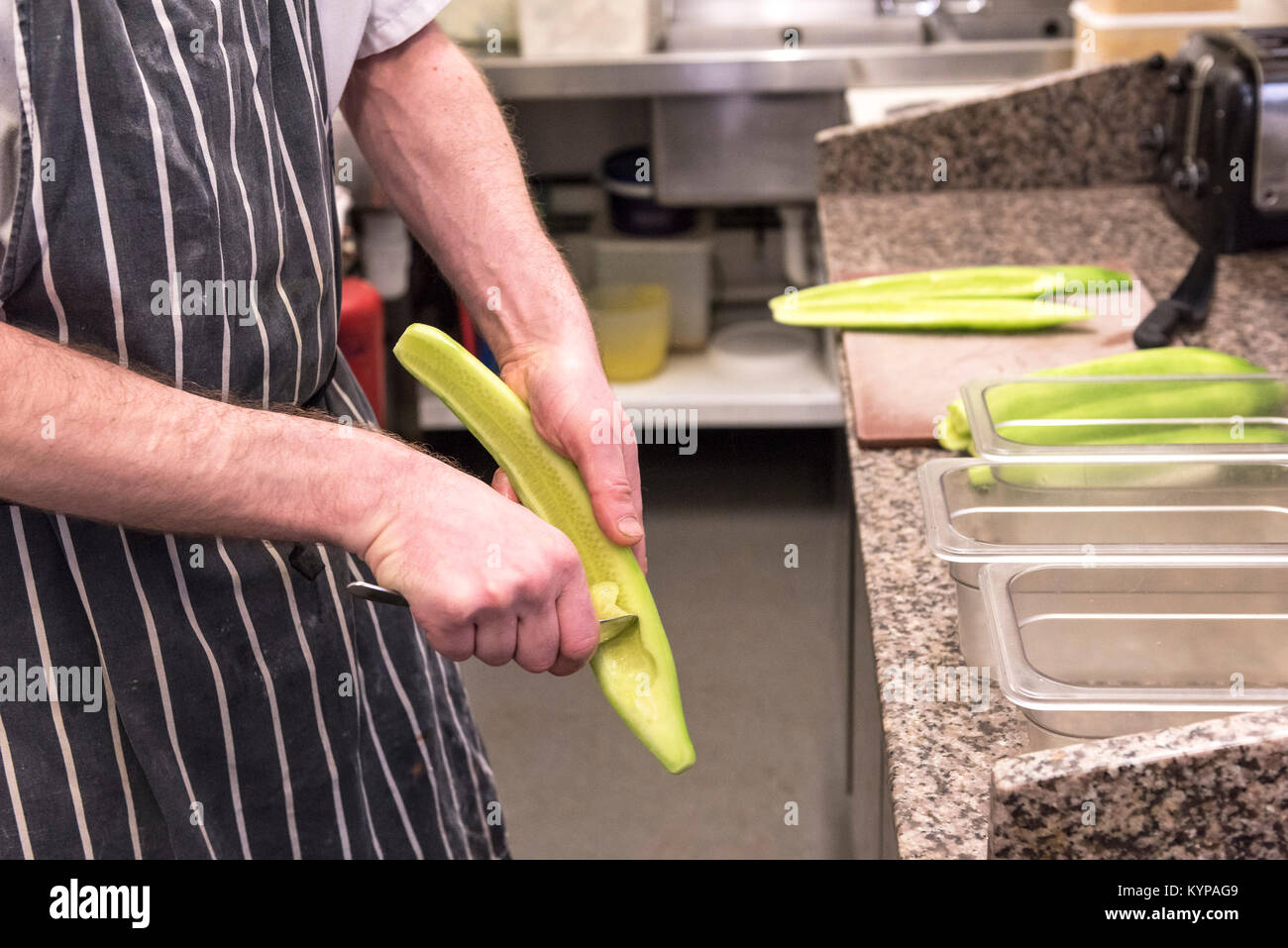 Food preparation - a chef preparing food in a restaurant kitchen Stock ...