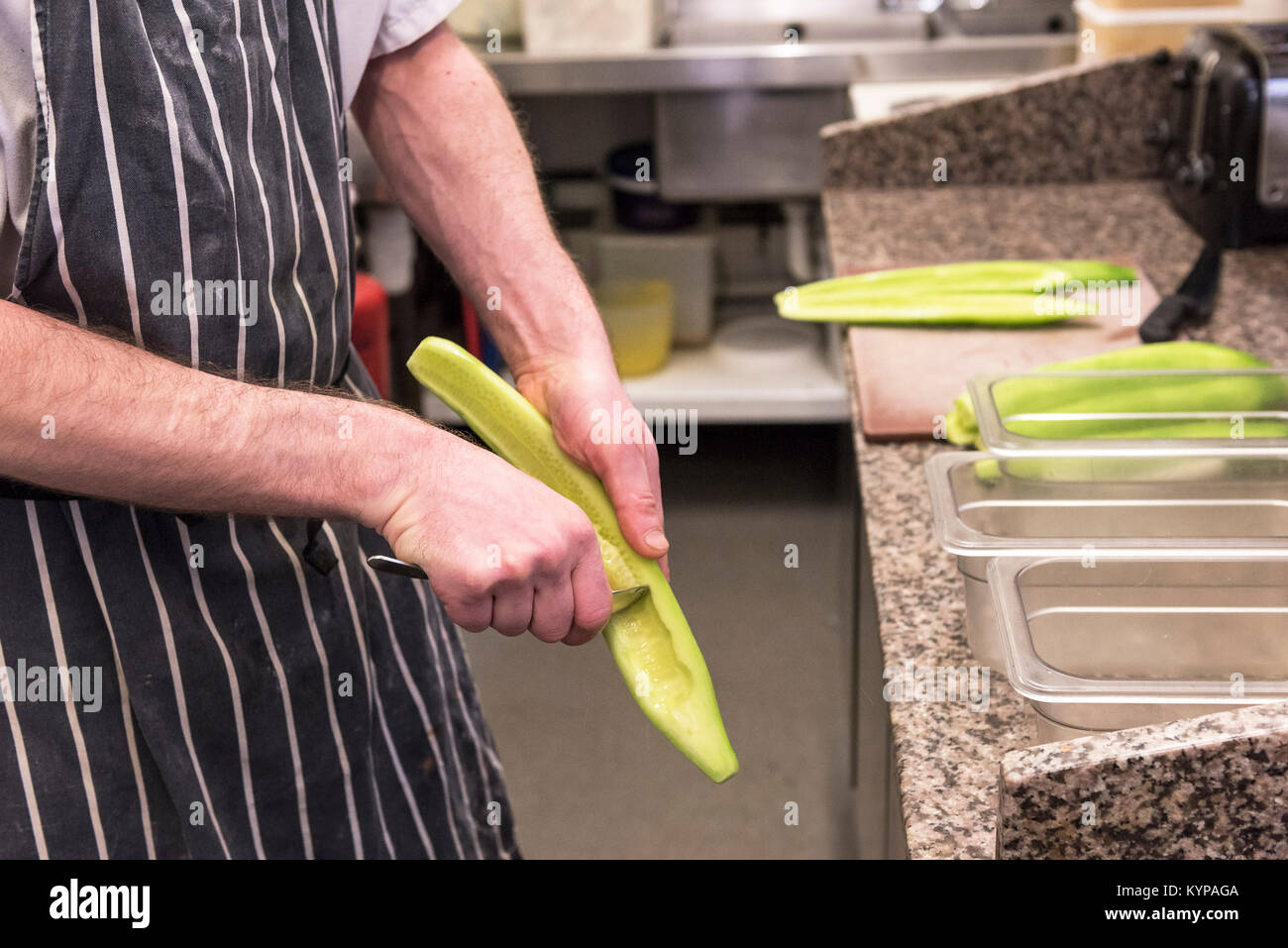 Food preparation - a chef preparing food in a restaurant kitchen Stock ...