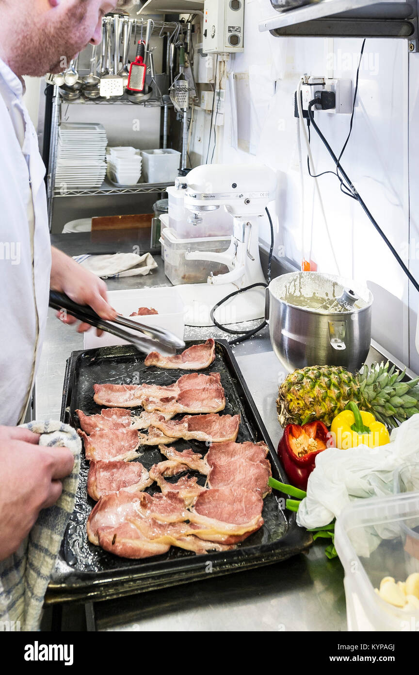 Food preparation - a chef preparing food in a restaurant kitchen Stock ...