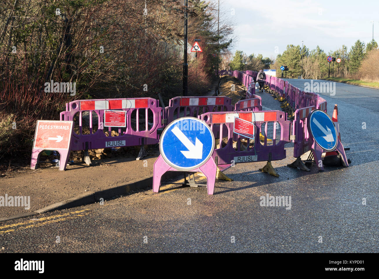 A footpath temporarily diverted onto a road using protective barriers ...