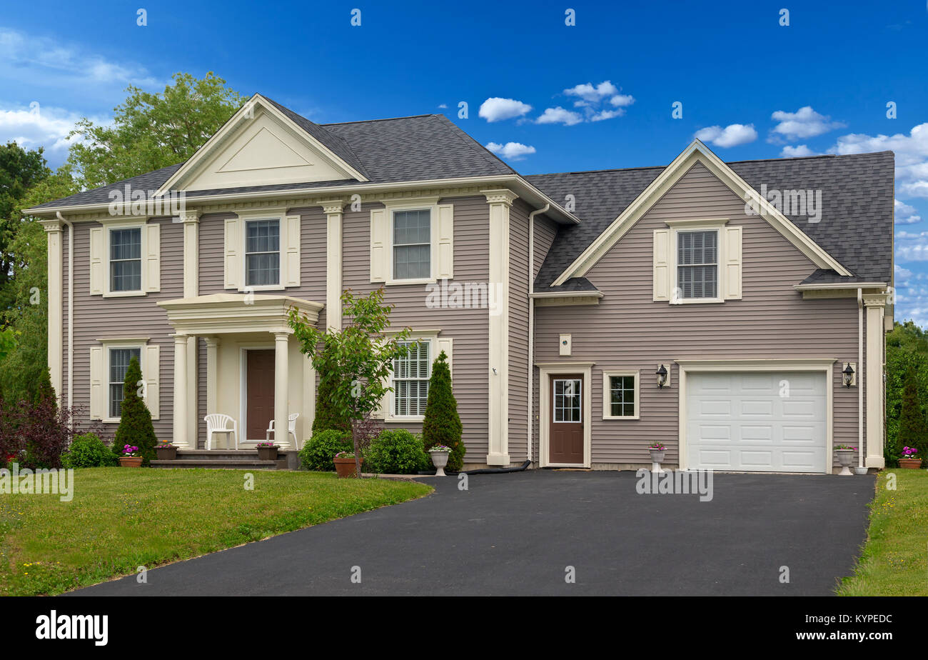 Luxury house with nicely trimmed and landscaped front yard, lawn in a ...